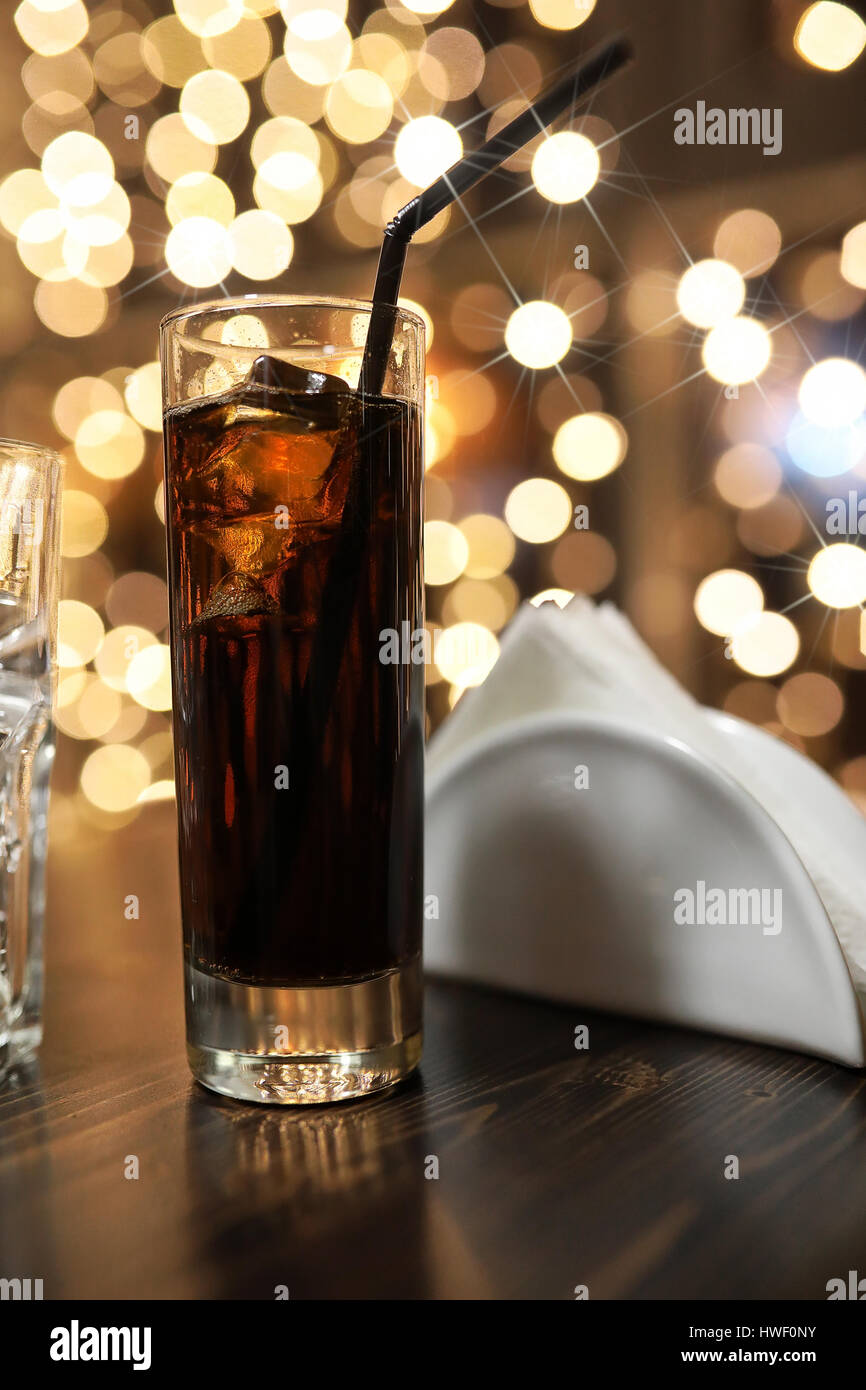 glass of cold alcohol drink with ice on table Stock Photo - Alamy