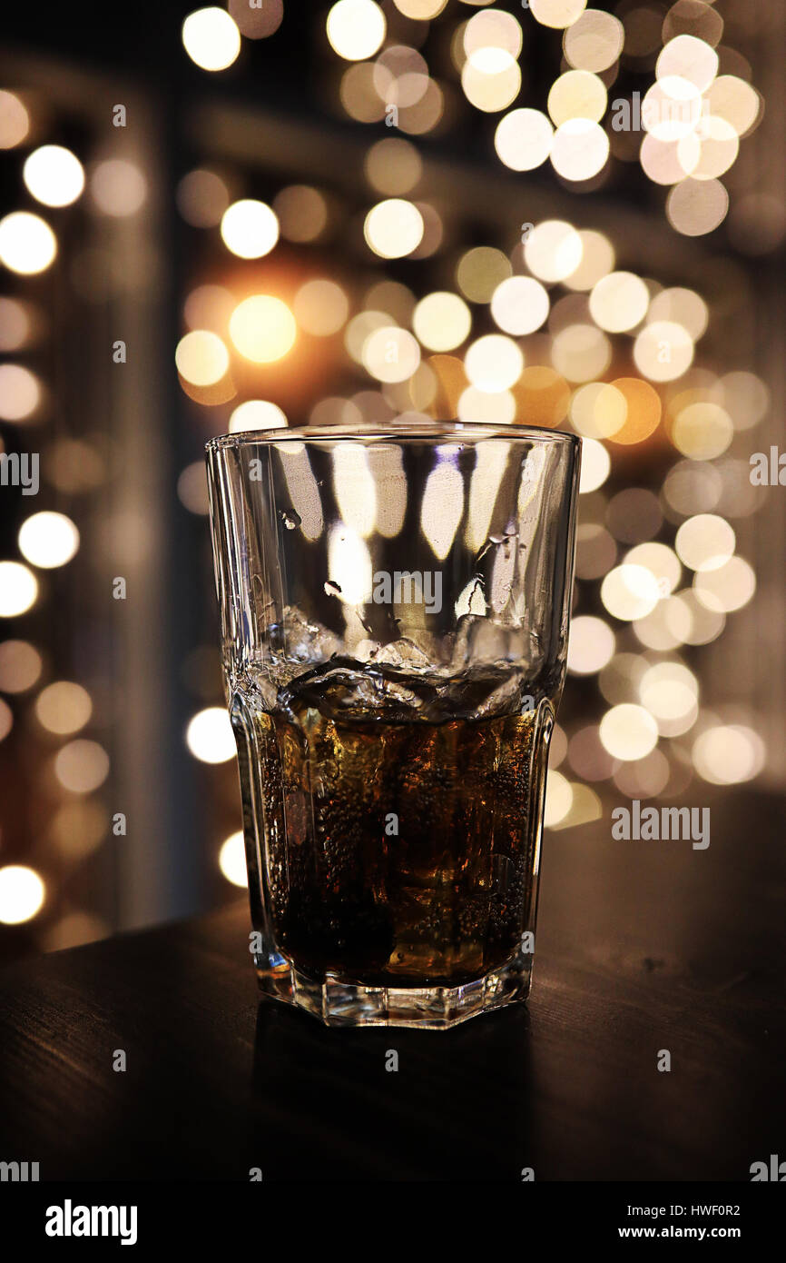 glass of alcohol with ice on blured background with circle bokeh Stock ...