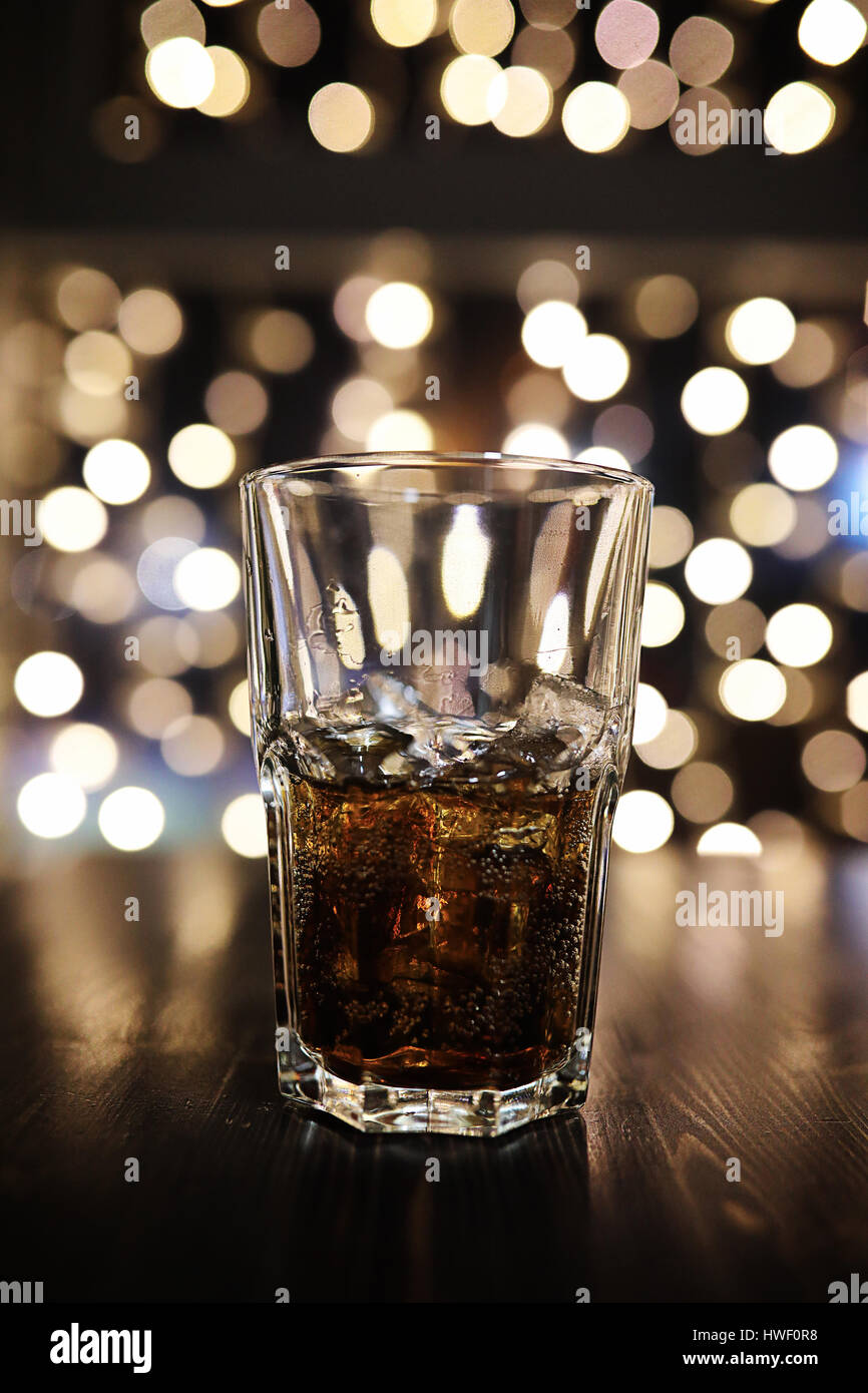 glass of alcohol with ice on blured background with circle bokeh Stock ...