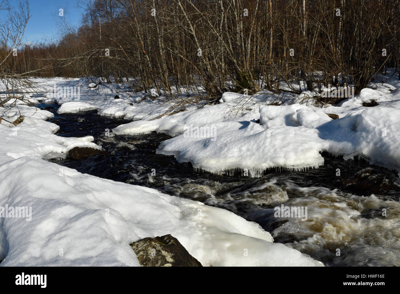 Little stream in the forest with ice and snow on both sides,picture ...