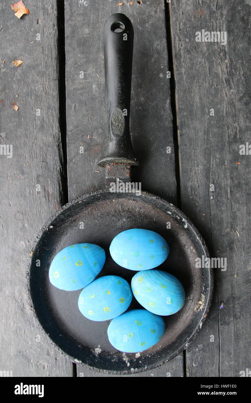 Easter eggs in a frying pan on a vintage wooden background Stock Photo ...