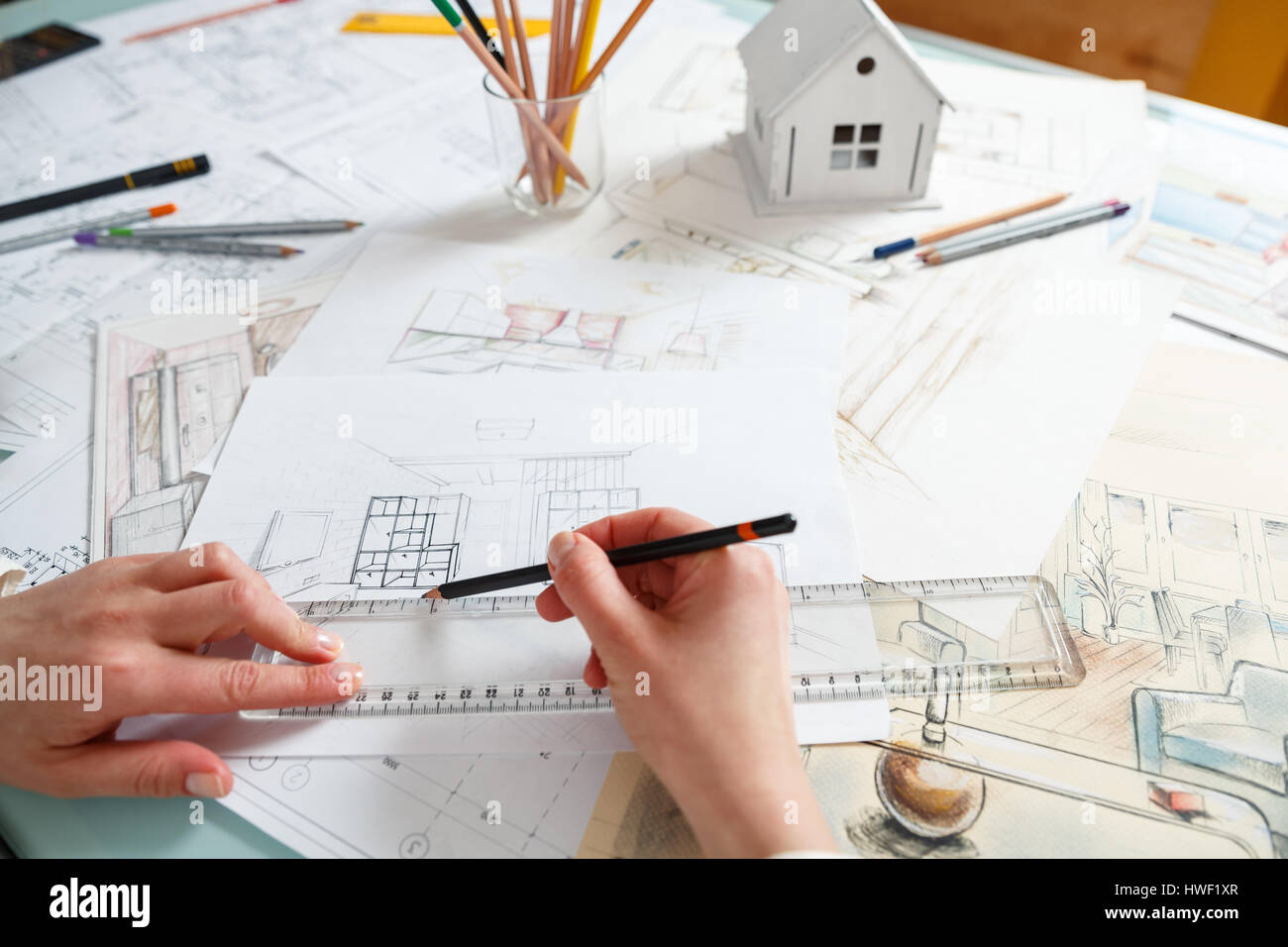 Interior designer working on color hand drawings of a kitchen interior ...