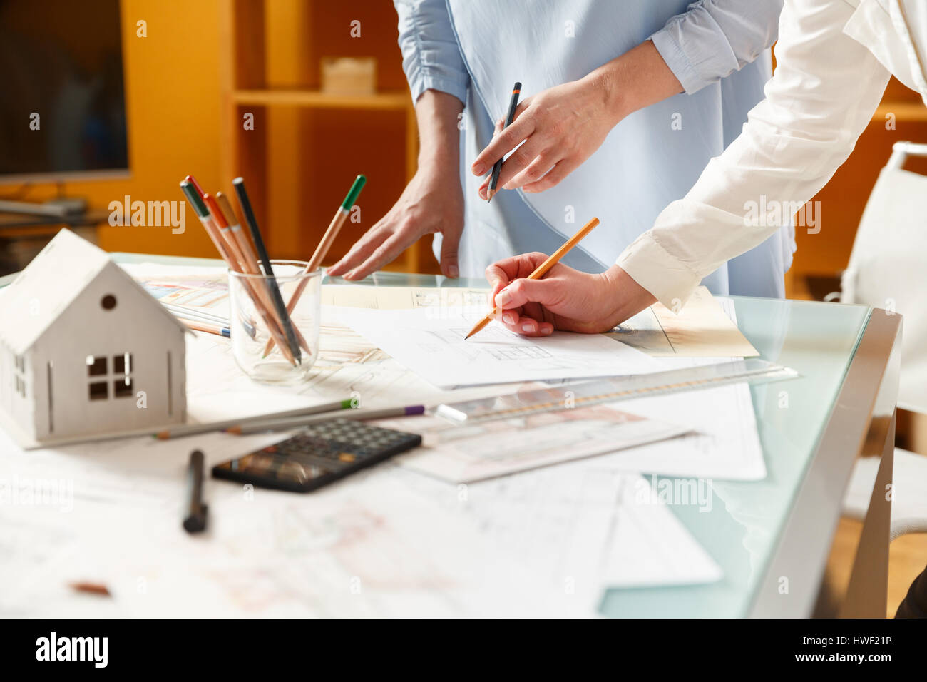 Interior designers working on hand drawings of interior at work place ...