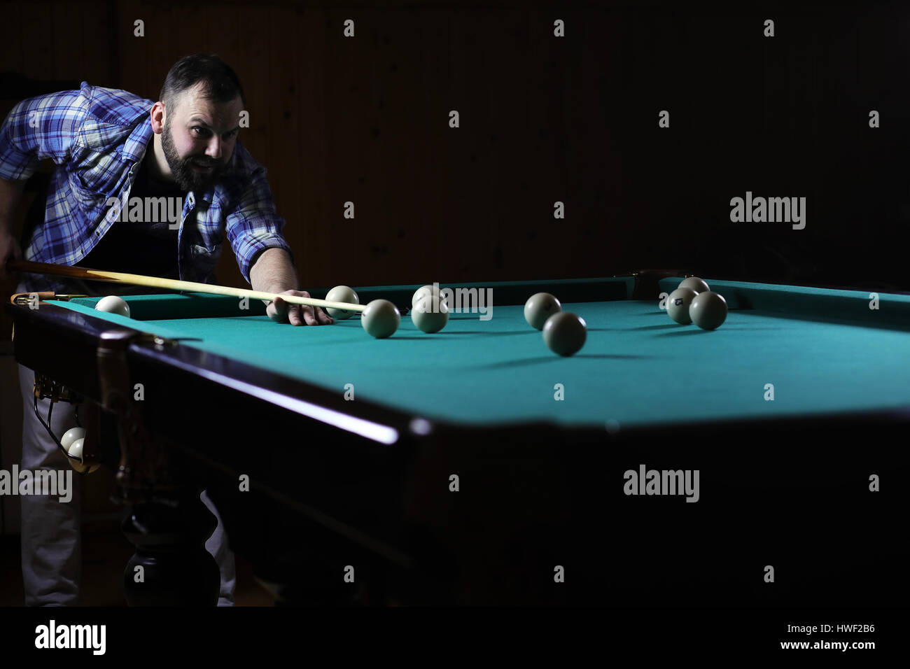 hansome man playing billiards alone Stock Photo - Alamy