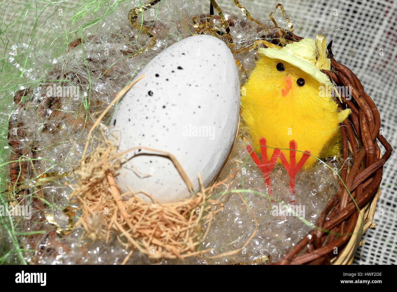 decorated egg with chick inside a wicker basket Stock Photo - Alamy