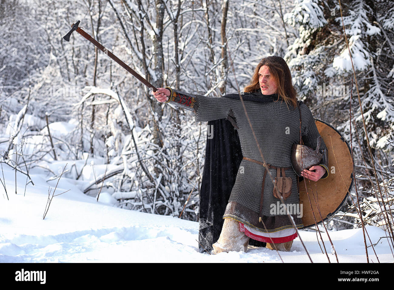 Defender the young warrior in mail armor armed with a sword Stock Photo ...