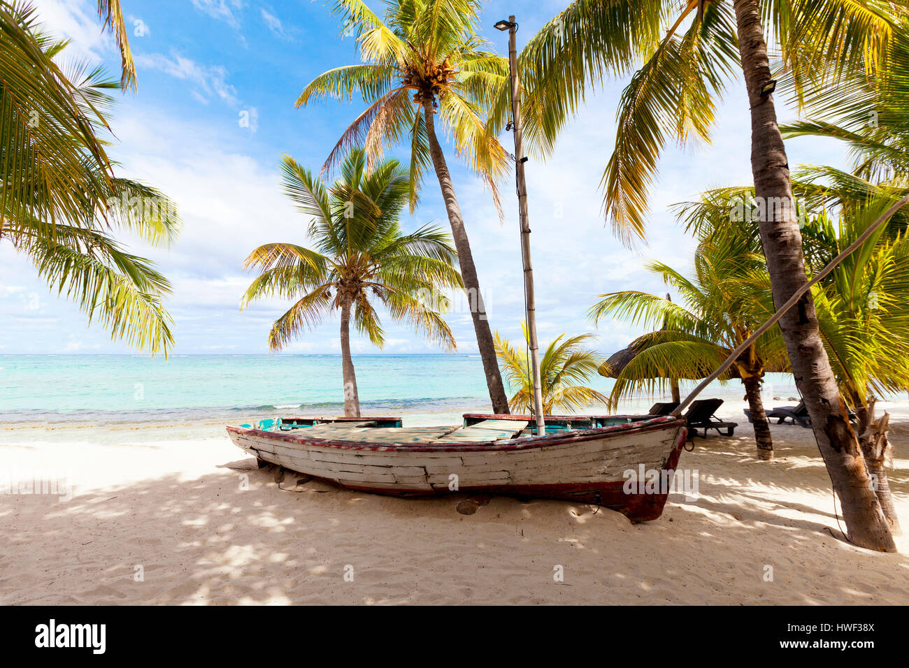 Old wooden fishing boat on a tropical paradise island with coconut palm ...