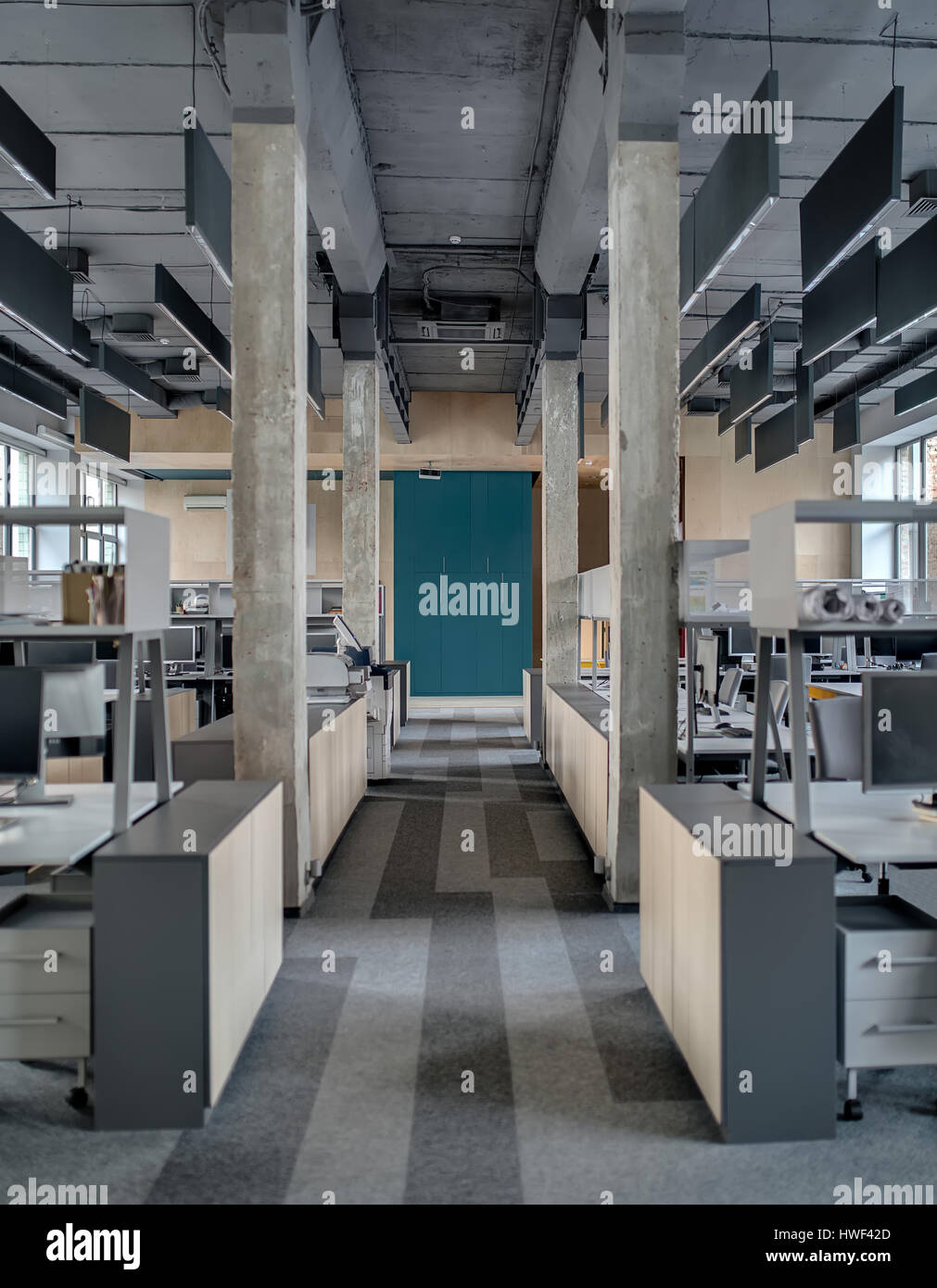 Hall in a loft style in the office with concrete columns and a gray ...