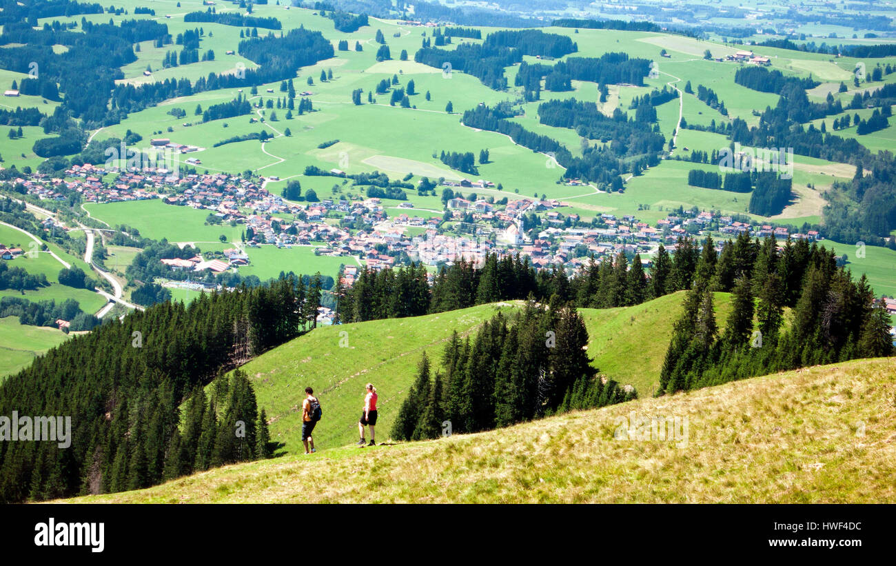 Hikers descending the Reuterwanne with the village of Wertach in the ...
