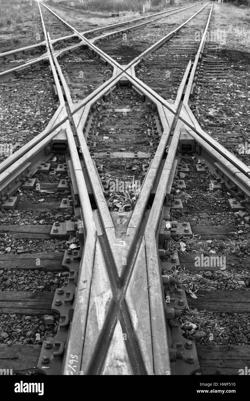 merging train tracks in black and white Stock Photo - Alamy