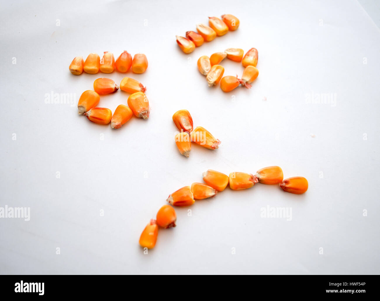 Healthy ecological corn in the form of angry smiley face on a white ...