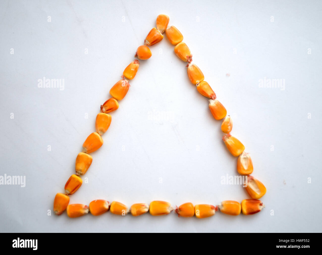 Healthy ecological corn in the form of a triangle on a white background ...