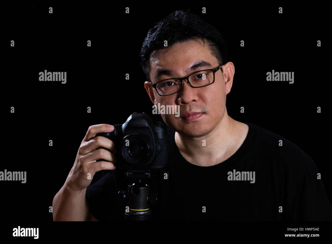 Asian Chinese Male Photographer Holding Digital SLR Camera in isolated ...