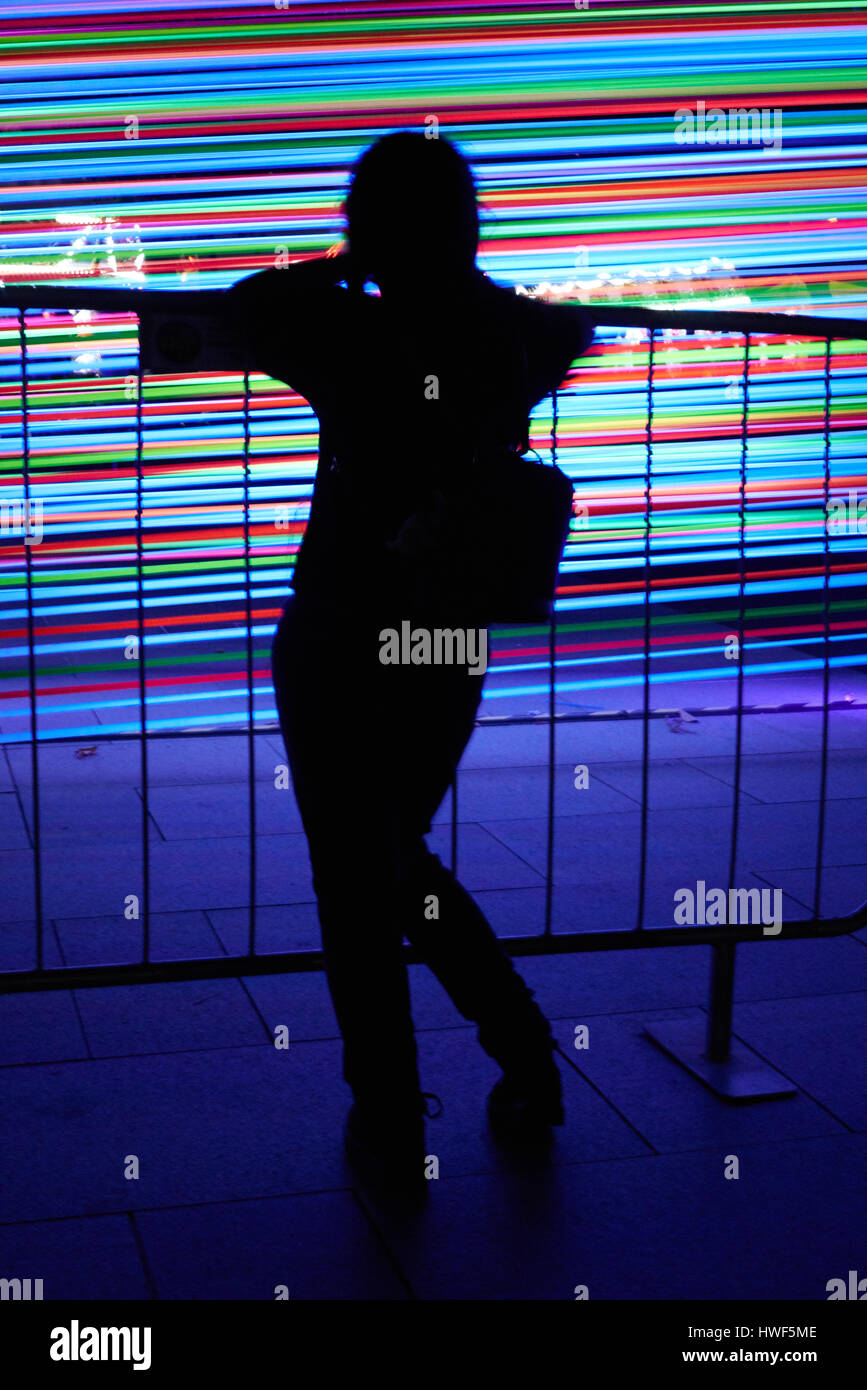 A girl staring into streaks of lights during the I Light Marina Bay ...