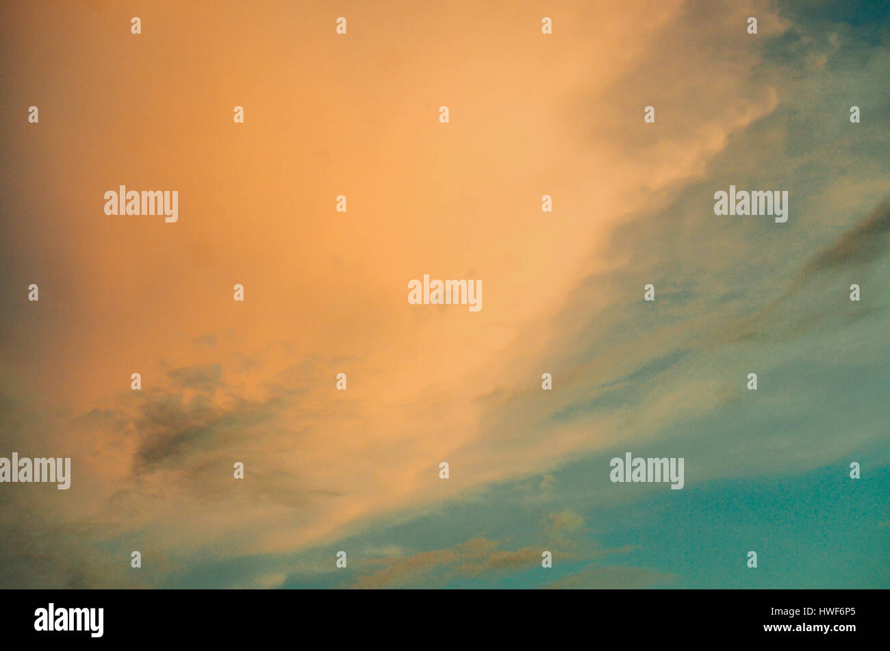 A simple sunset where the clouds are mostly orange and yellow and blue ...
