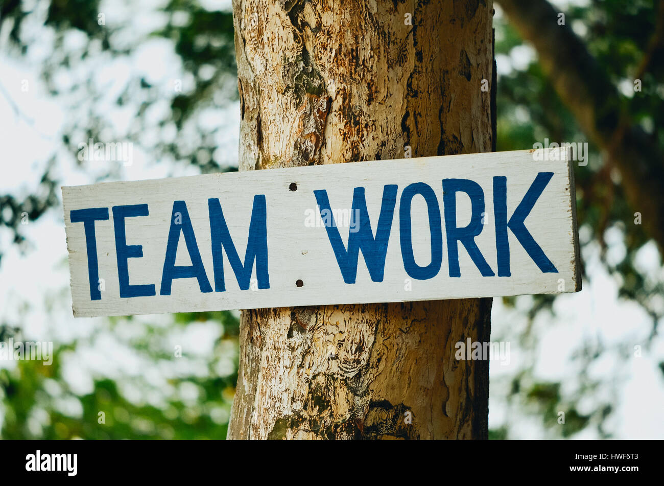 A handmade teamwork sign in blue paint on a white sign. The sign is ...