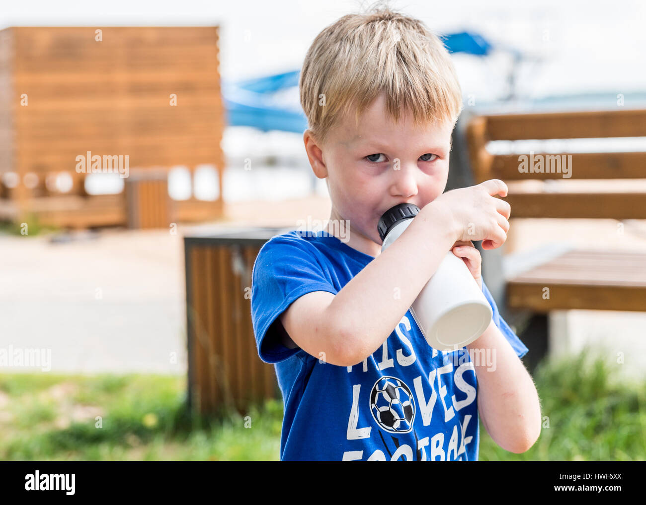 Day light portrait of boy drinking water outdoor Stock Photo - Alamy