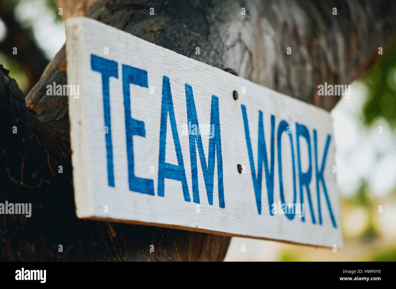 A handmade teamwork sign in blue paint on a white sign. The sign is ...