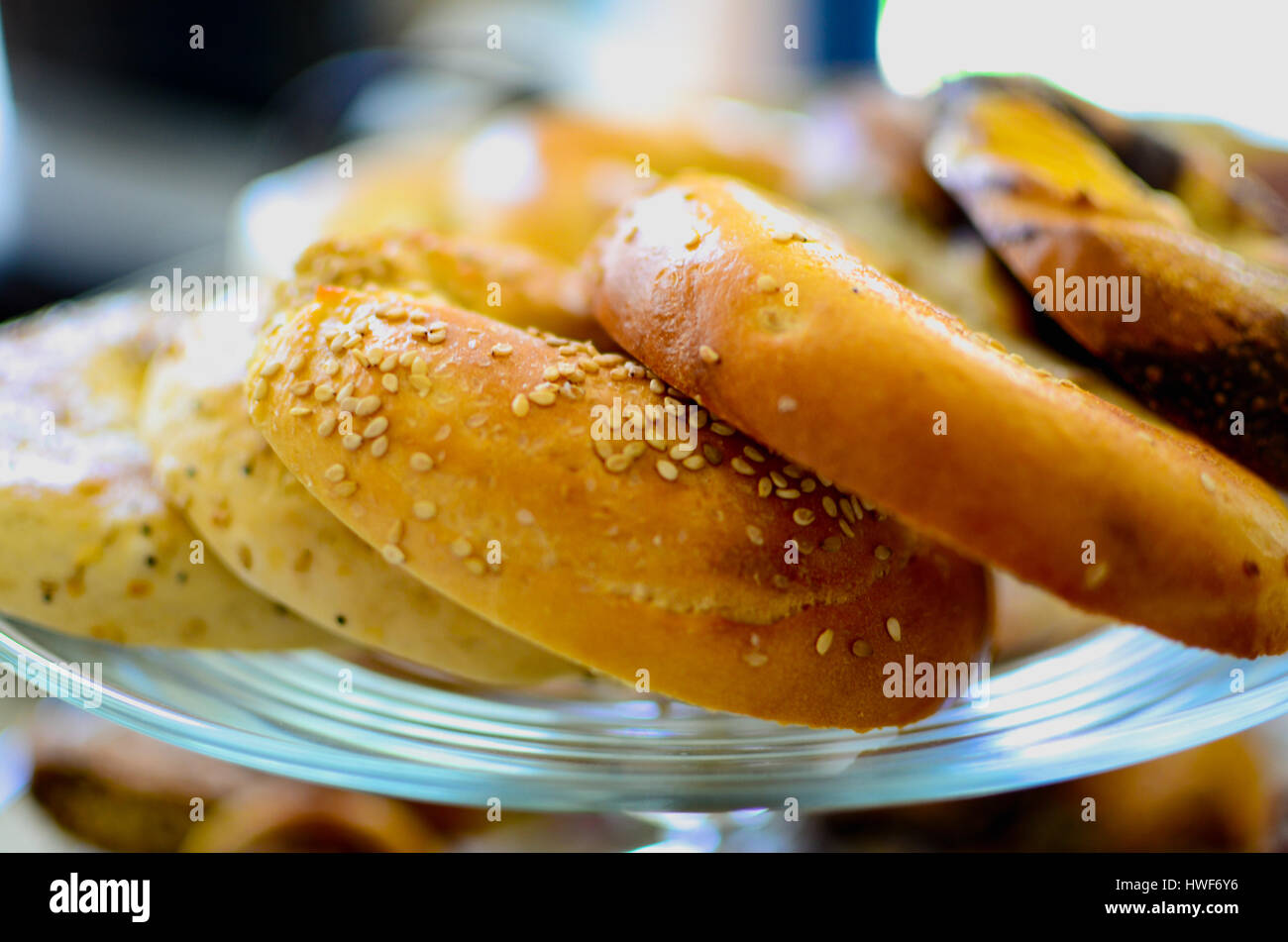 Sesame, everything, plain and more bagles. They're cut in to halfs and arranged on a plate Stock ...