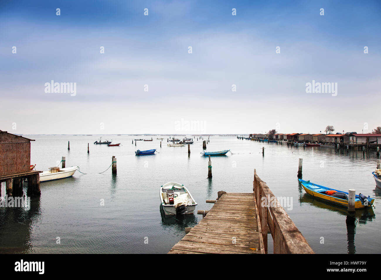 Boats and fishing huts, lagoon Comacchio valleys, Emilia Romagna Italy ...