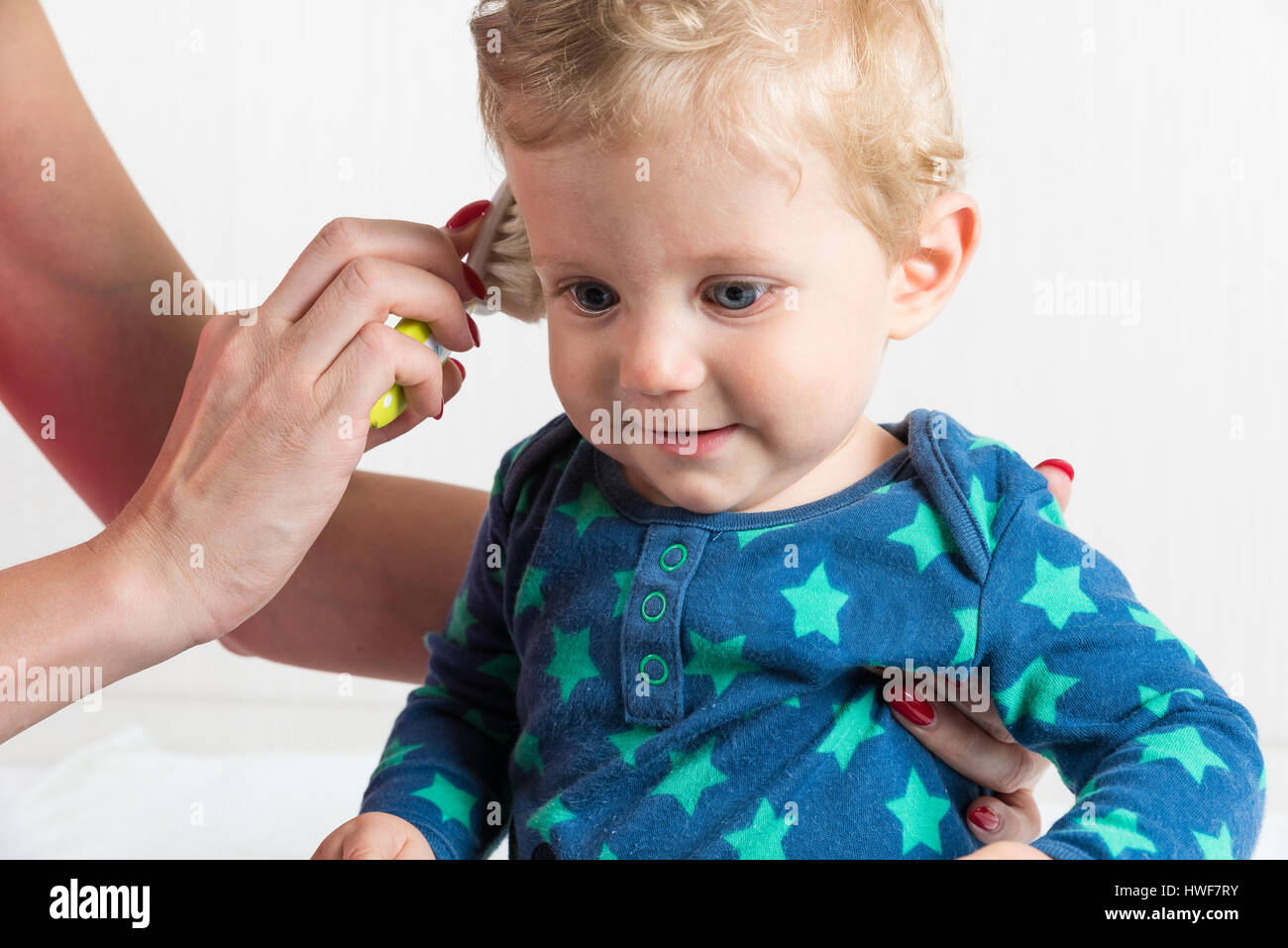 Mother combing hair of baby hi-res stock photography and images - Alamy
