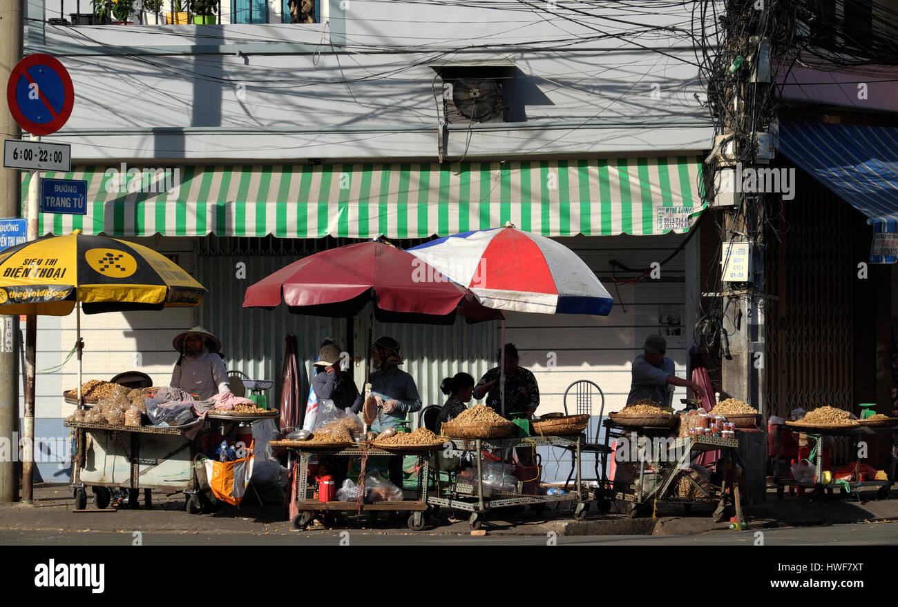 Ho Chi Minh city, Viet Nam, Vietnamese people sell peanut on pavement ...