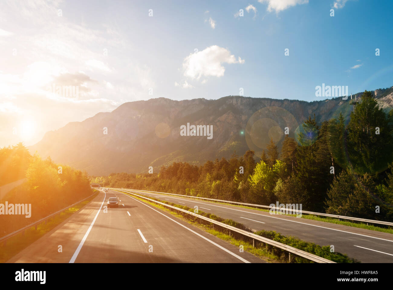 Autobahn in austrian mountains at sunset Stock Photo - Alamy