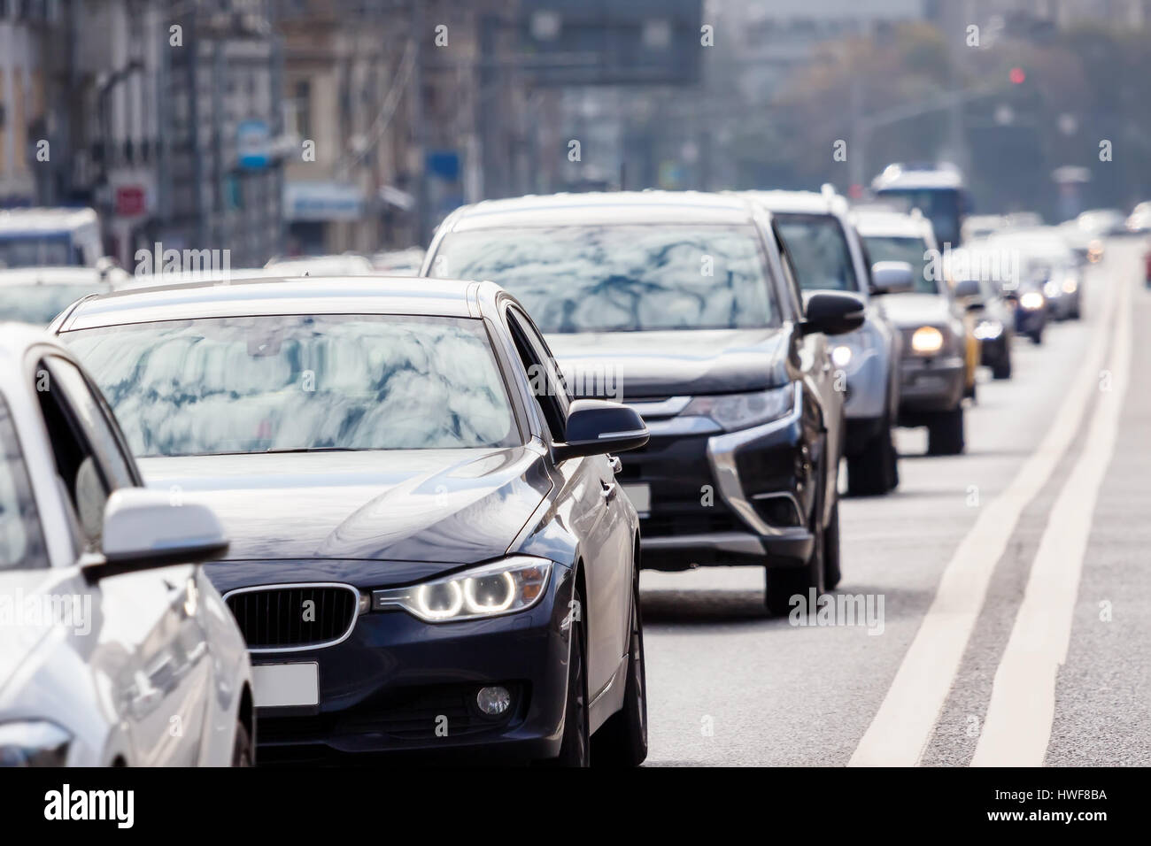 Cars in a long queue on the busy city street Stock Photo - Alamy