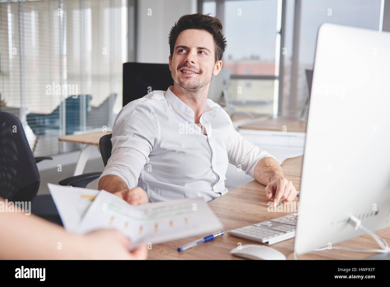 Confident man working at his work station Stock Photo - Alamy