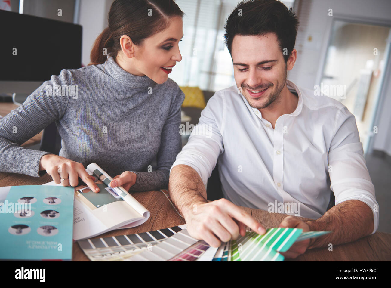 Business couple reviewing patterns at office Stock Photo - Alamy