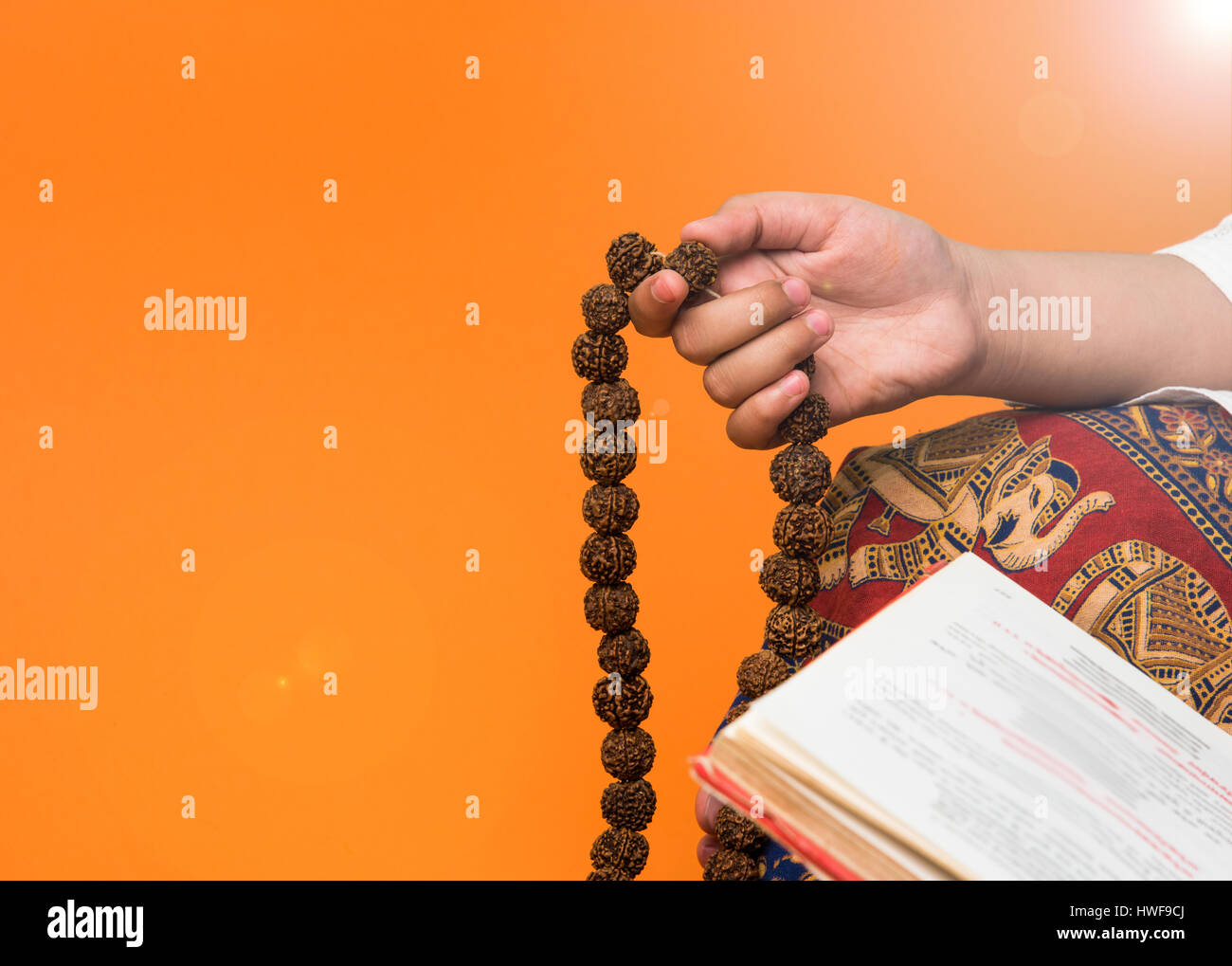 closeup picture of hand while doing Meditation with rudraksha mala or ...