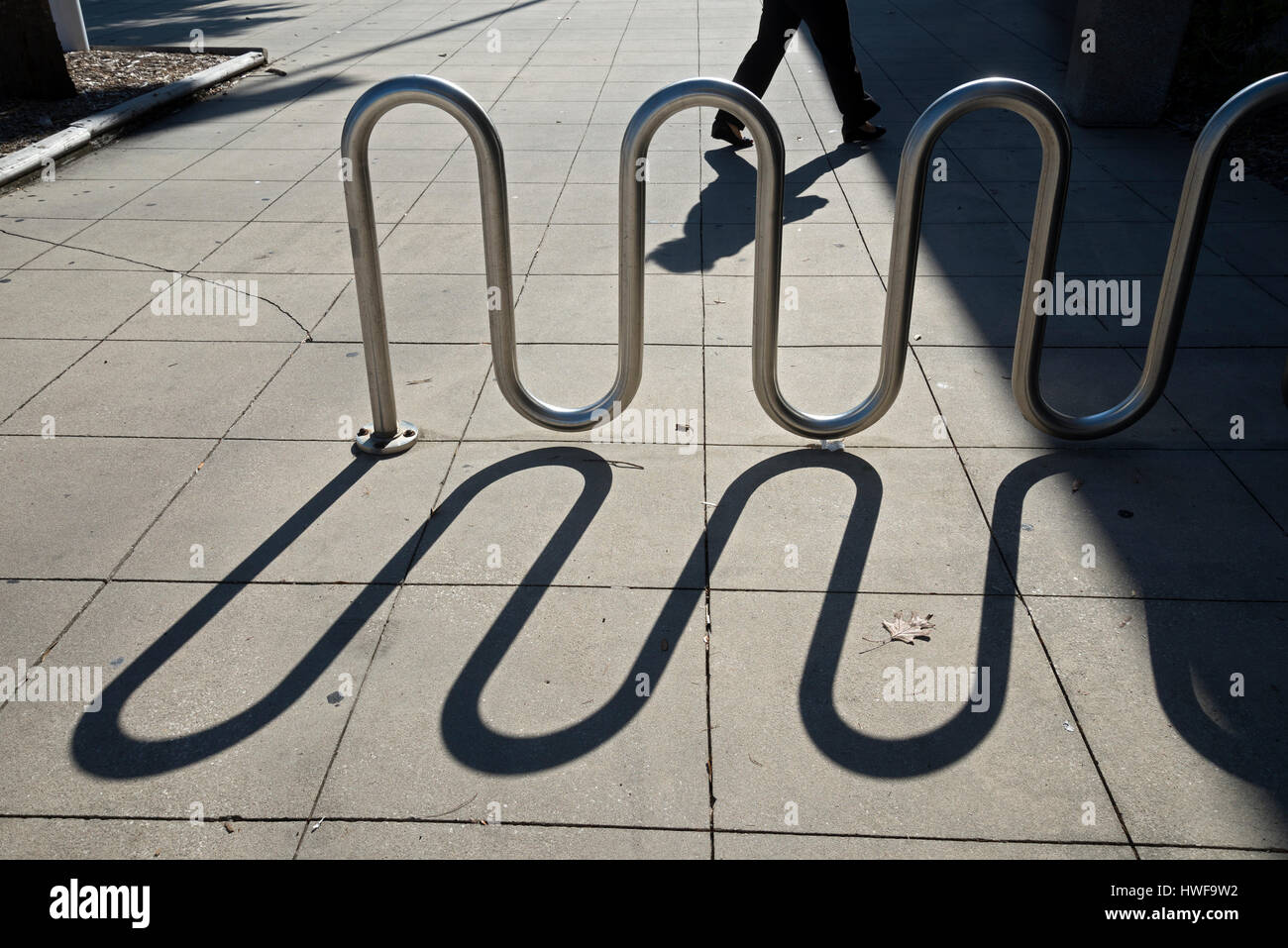 Shadow of a bicycle rack on a sidewalk Stock Photo - Alamy