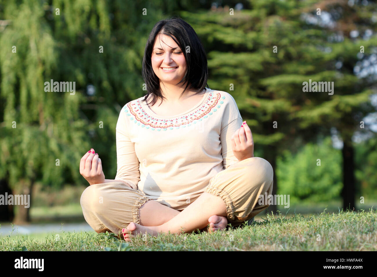 beautiful girl meditating in park Stock Photo - Alamy