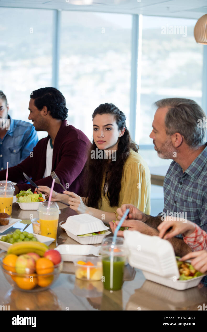 Creative business team having meal in office Stock Photo - Alamy