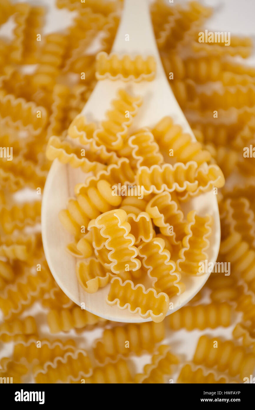 Gnocchi pasta spilling out of spoon on white background Stock Photo - Alamy
