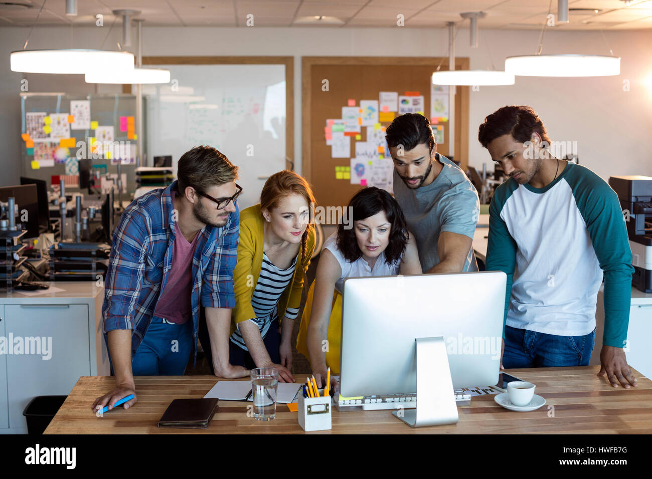 Creative business team working together on desktop pc in office Stock ...
