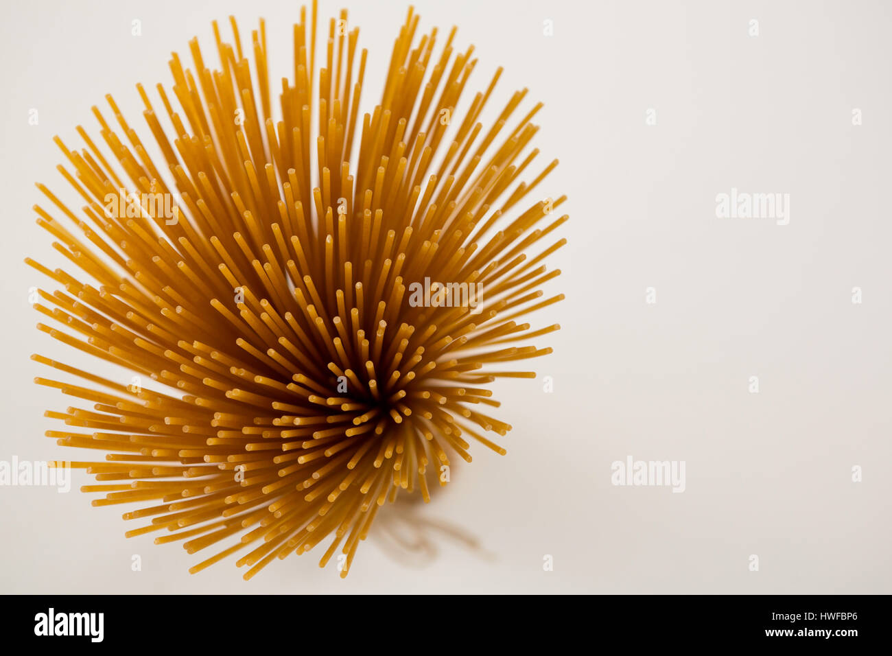 Bundle of raw spaghetti on white background Stock Photo - Alamy