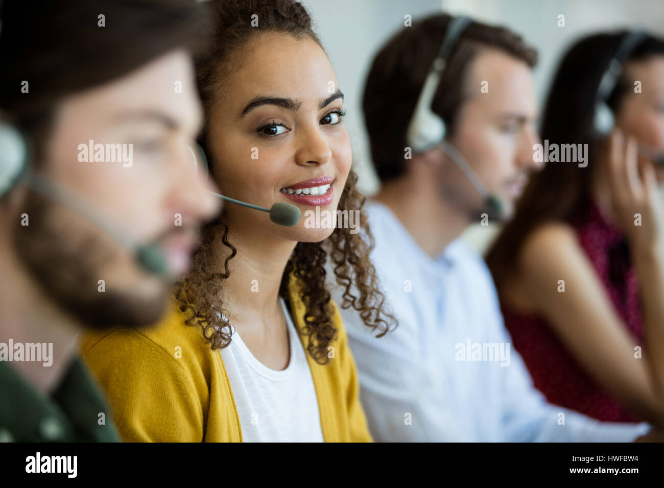 Portrait of customer service executive working at office Stock Photo ...