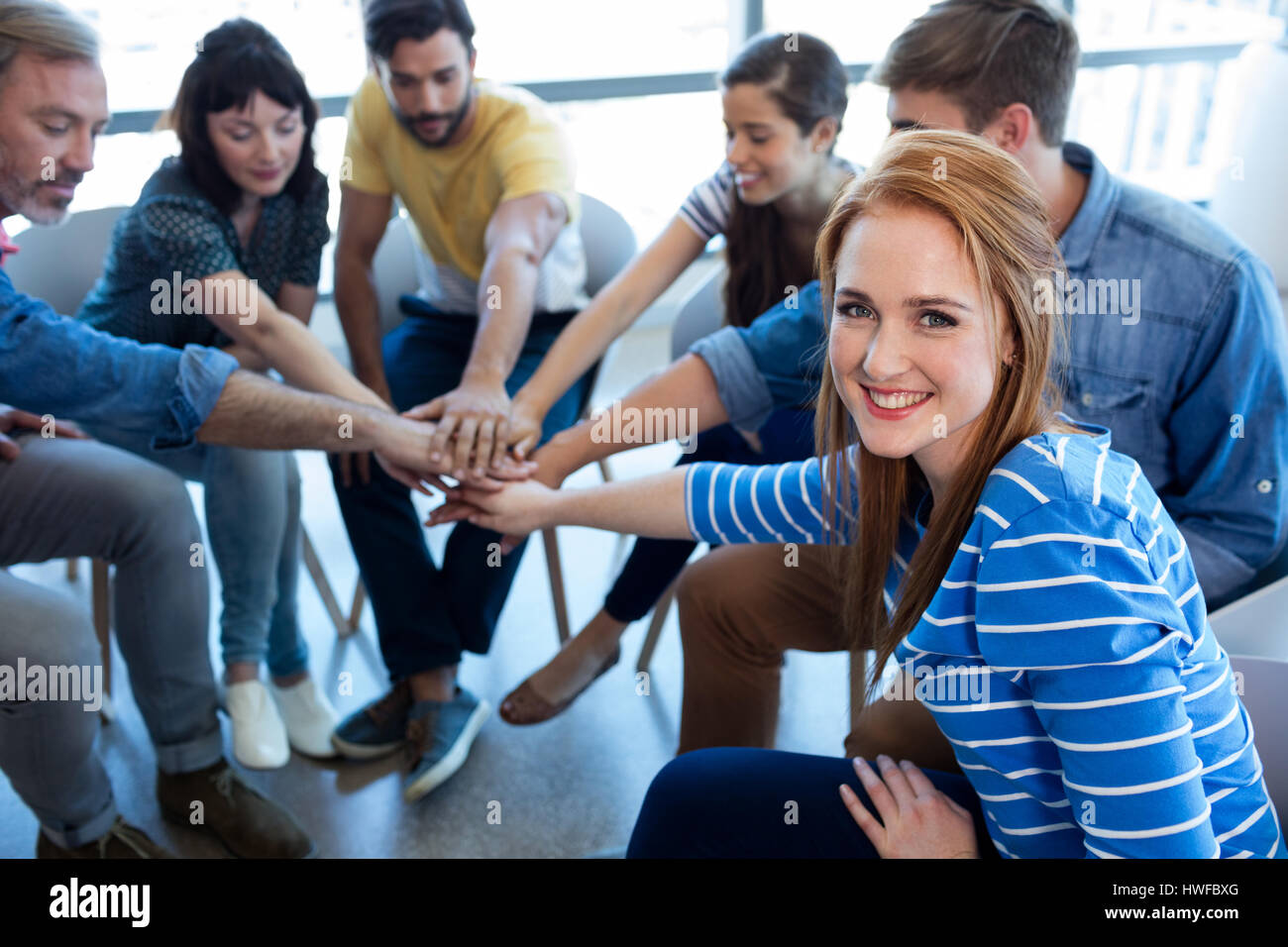 Creative business team putting their hands together in office Stock ...