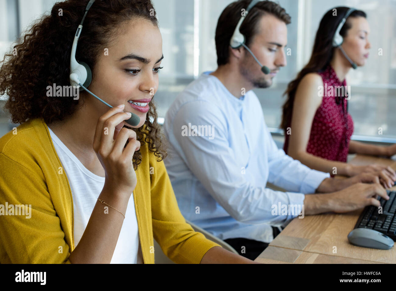 Customer service executives working at office Stock Photo - Alamy