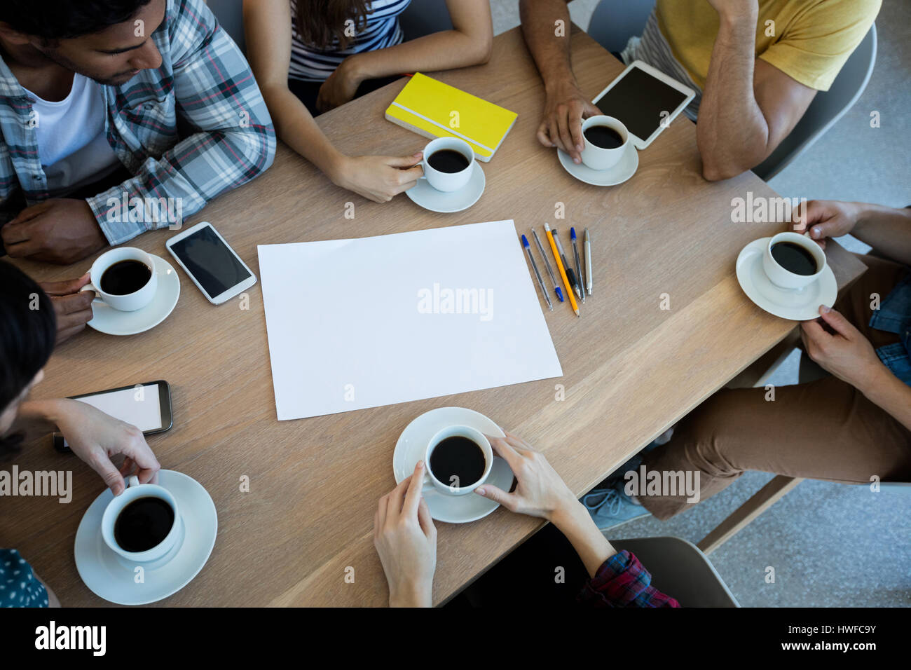 Creative business team having meeting over coffee in meeting room in ...