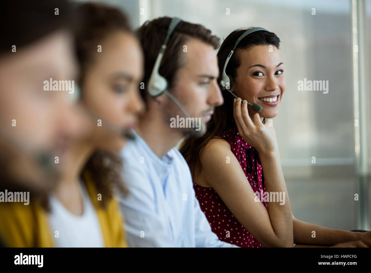 Portrait of customer service executive working at office Stock Photo ...