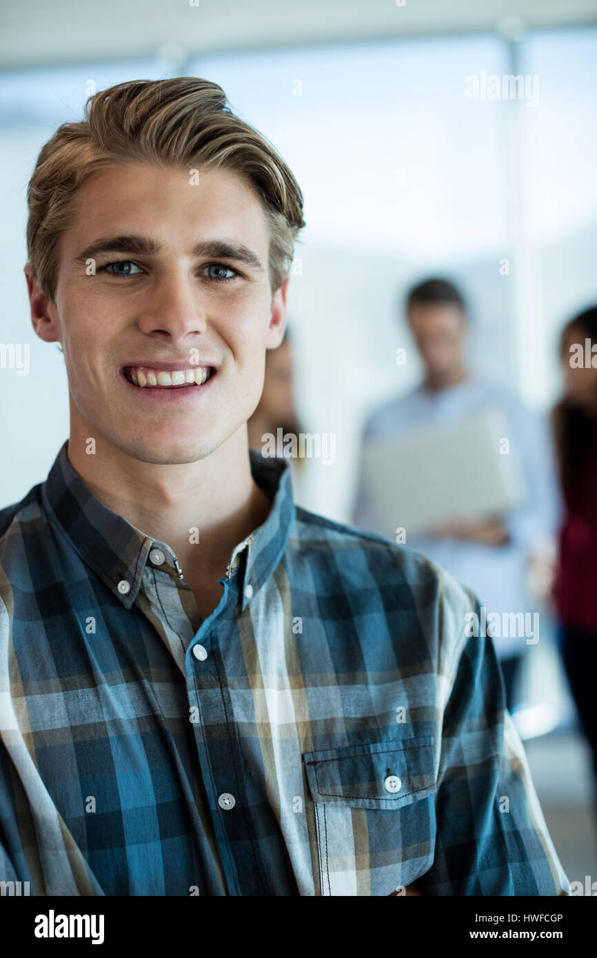 Portrait of smiling man standing in office Stock Photo - Alamy
