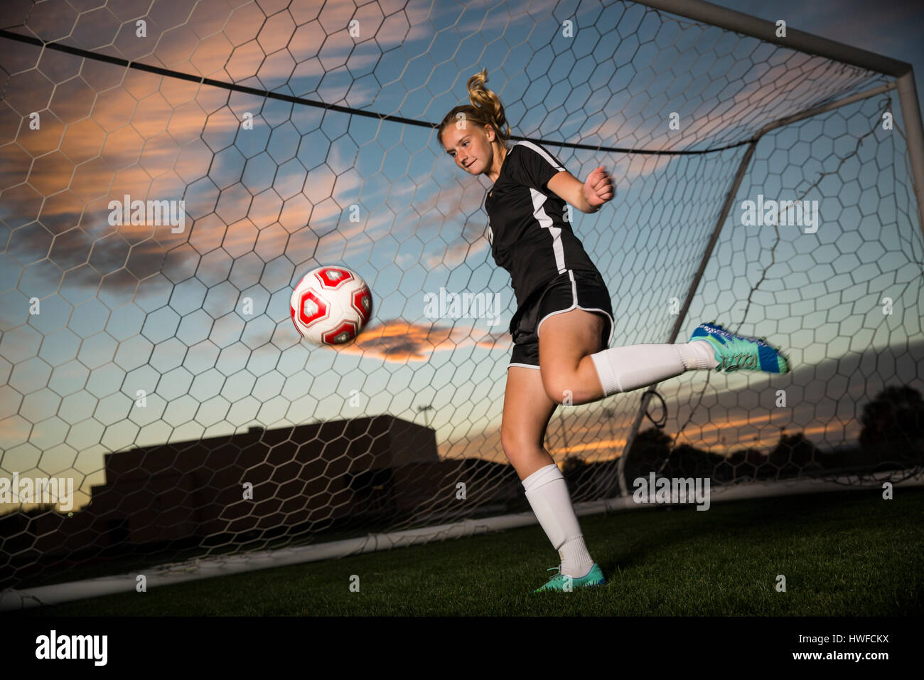 Kicking soccer ball hi-res stock photography and images - Alamy