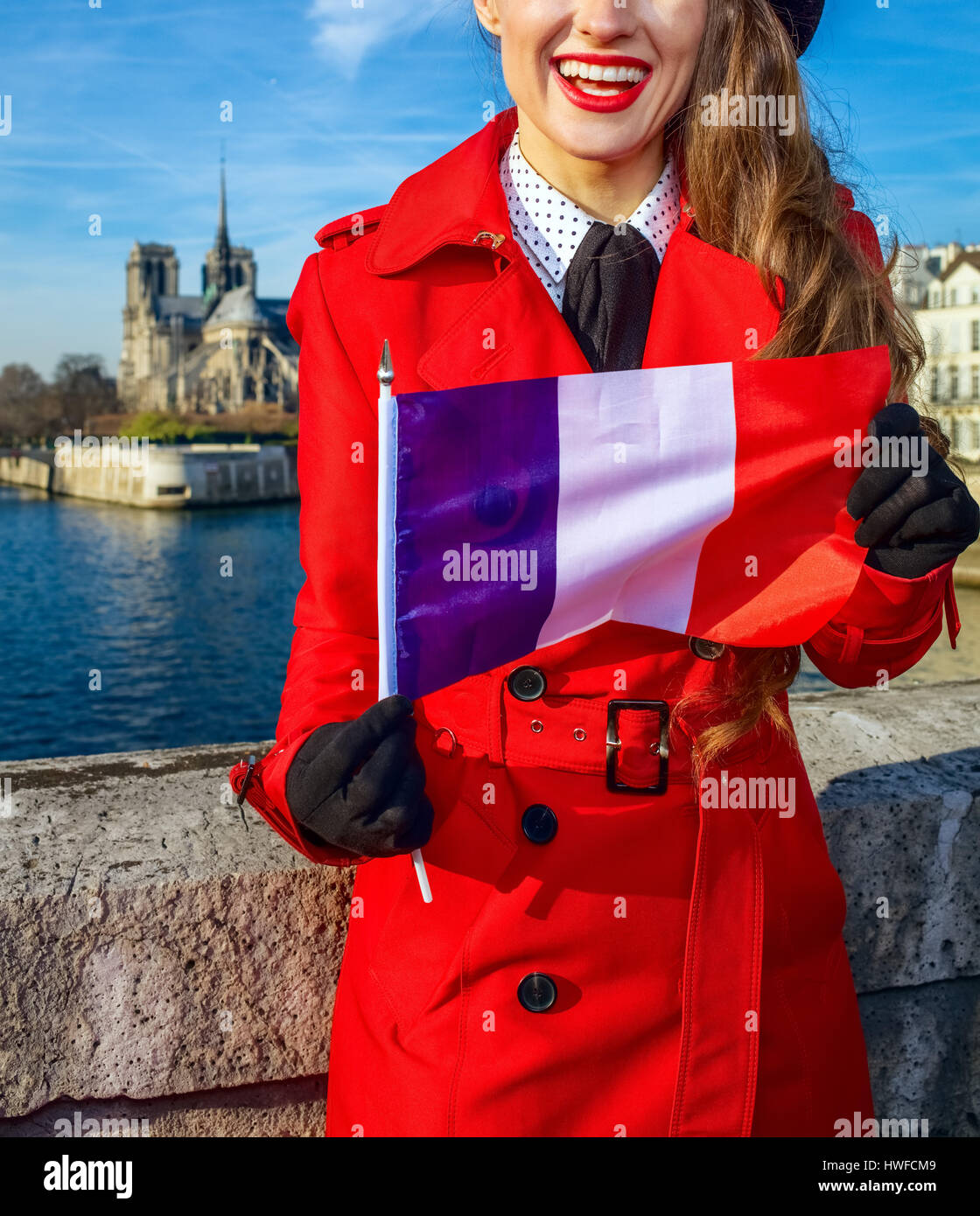 Bright in Paris. happy stylish woman in red trench coat on embankment ...