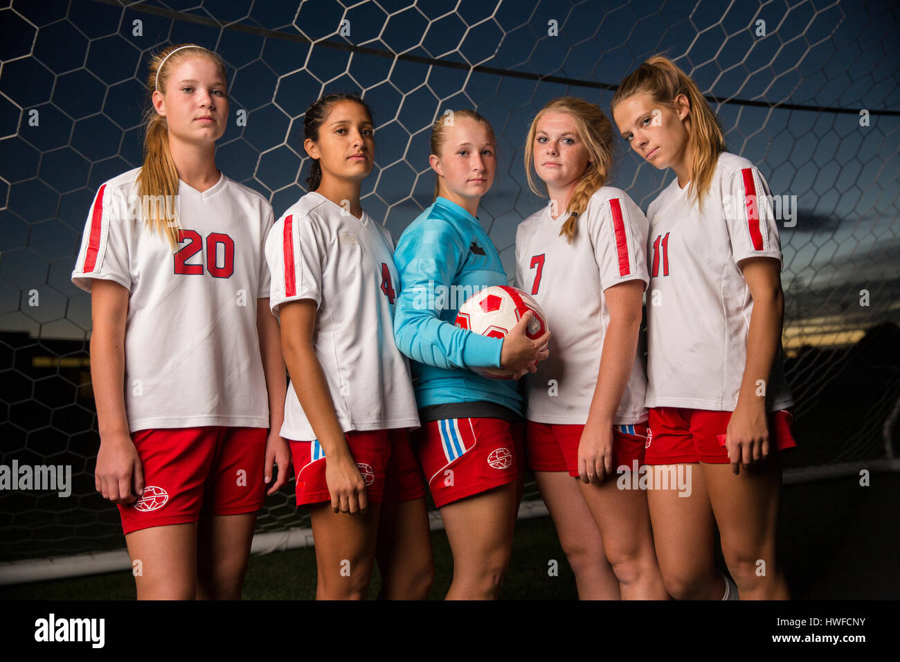 Portrait of serious soccer team standing in goal under sunset sky Stock ...