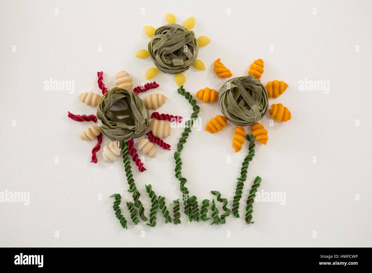 Varieties of pasta forming flower on white background Stock Photo - Alamy