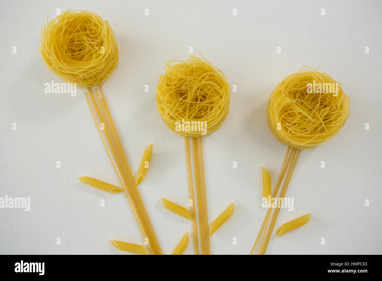 Varieties of pasta forming flower on white background Stock Photo - Alamy