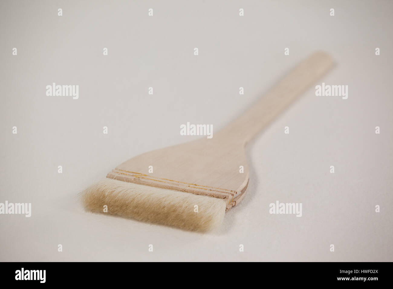 Close-up of flat paint brush against white background Stock Photo - Alamy
