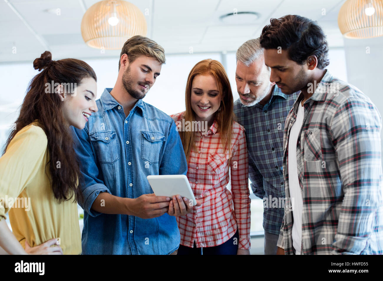 Creative business team using digital tablet in office Stock Photo - Alamy